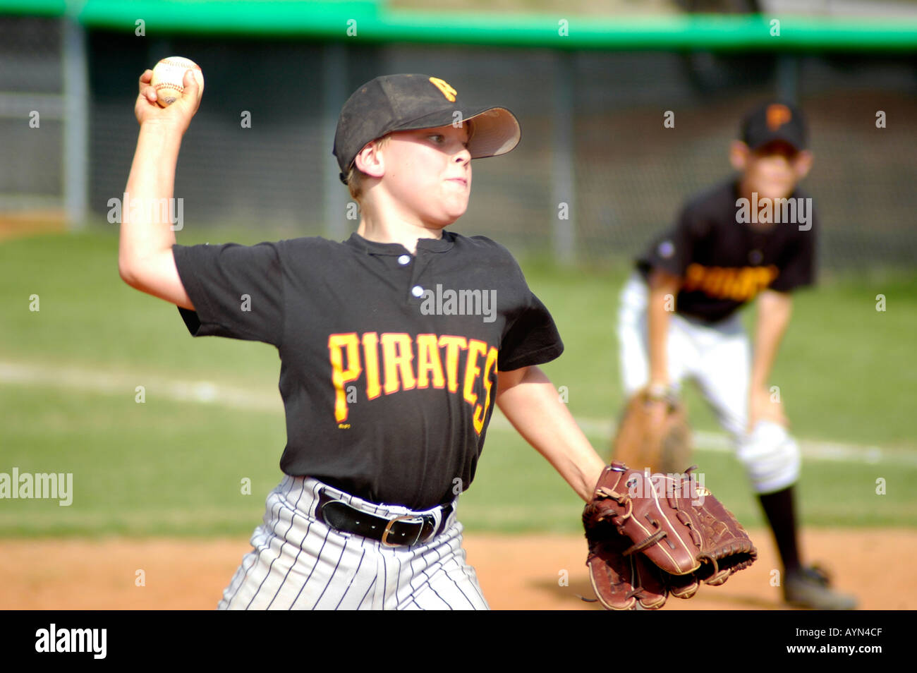Young boys playing baseball on ball field Pitcher Stock Photo - Alamy