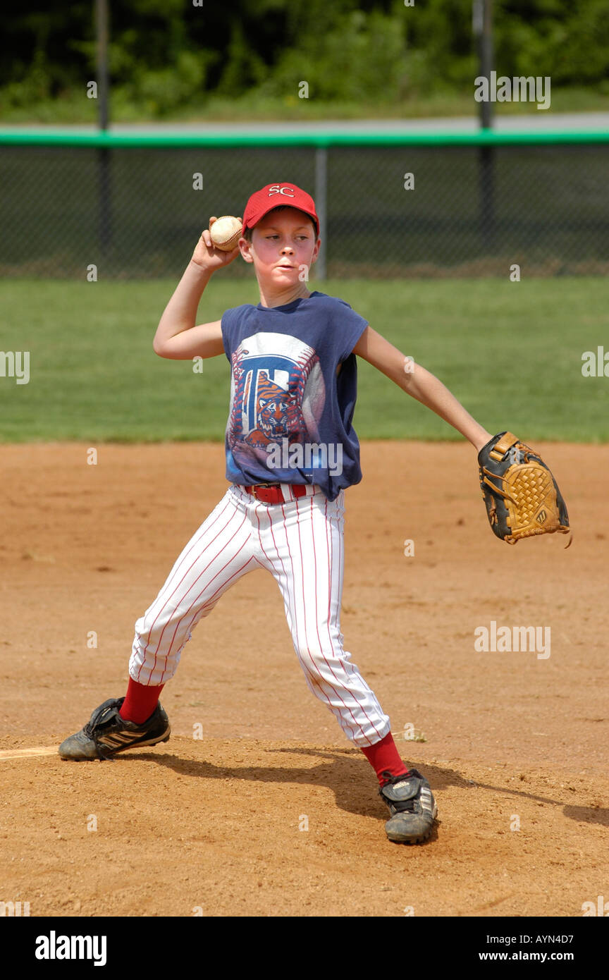 Young boys playing baseball on ball field Pitcher Stock Photo - Alamy