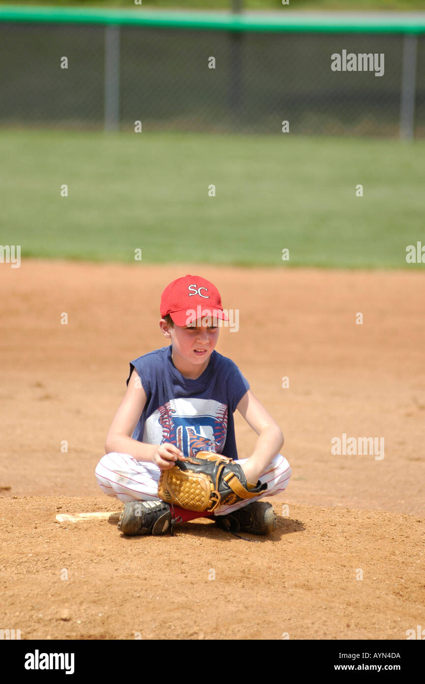 Young boy playing baseball on ball field Stock Photo - Alamy