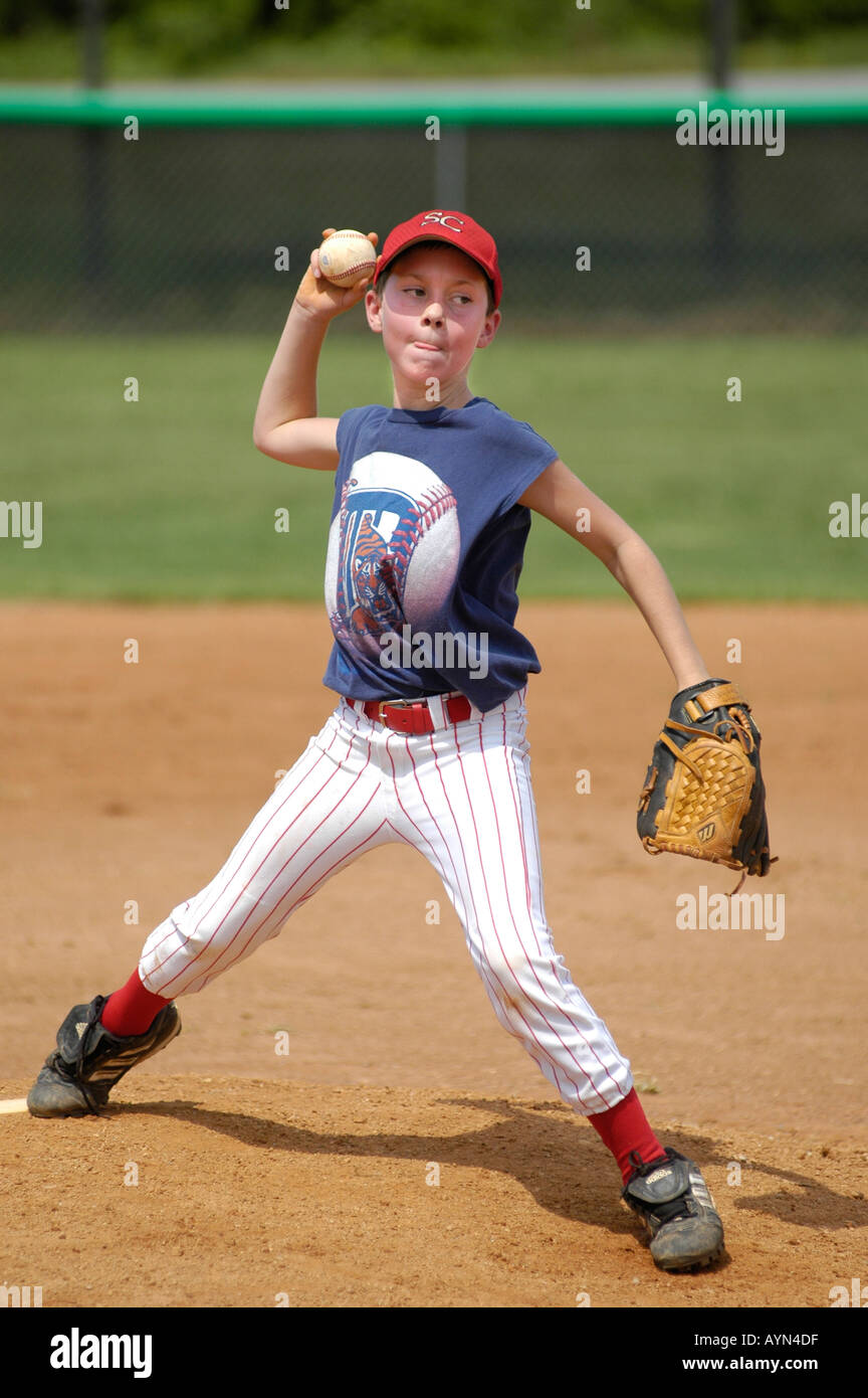 Young boy playing baseball on ball field Pitcher Stock Photo - Alamy