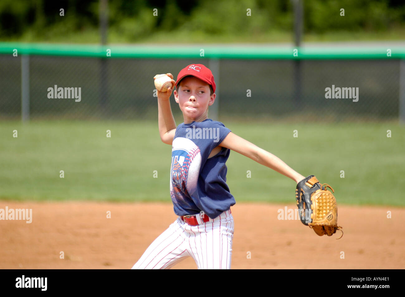 Young boy playing baseball on ball field Pitcher Stock Photo - Alamy
