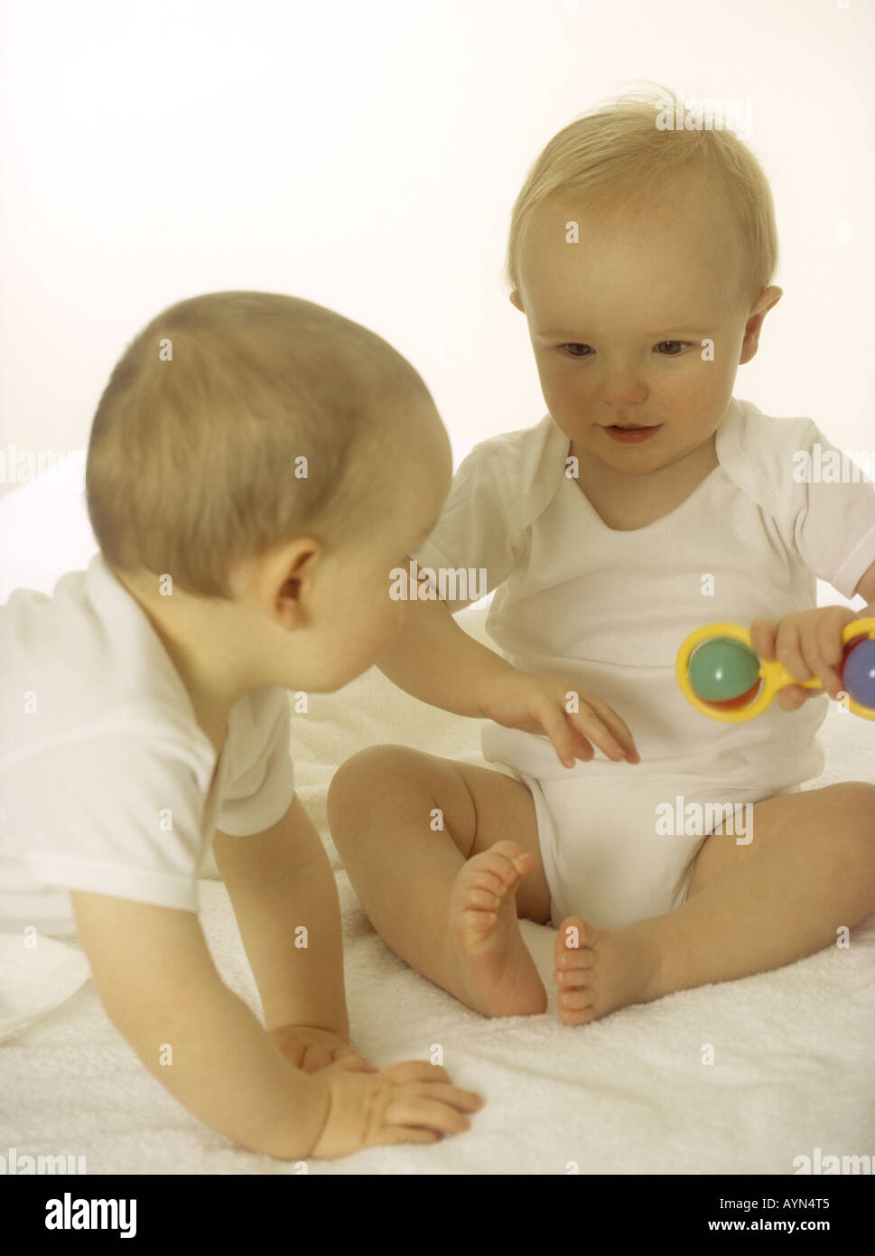Two baby boys playing happily together Stock Photo - Alamy