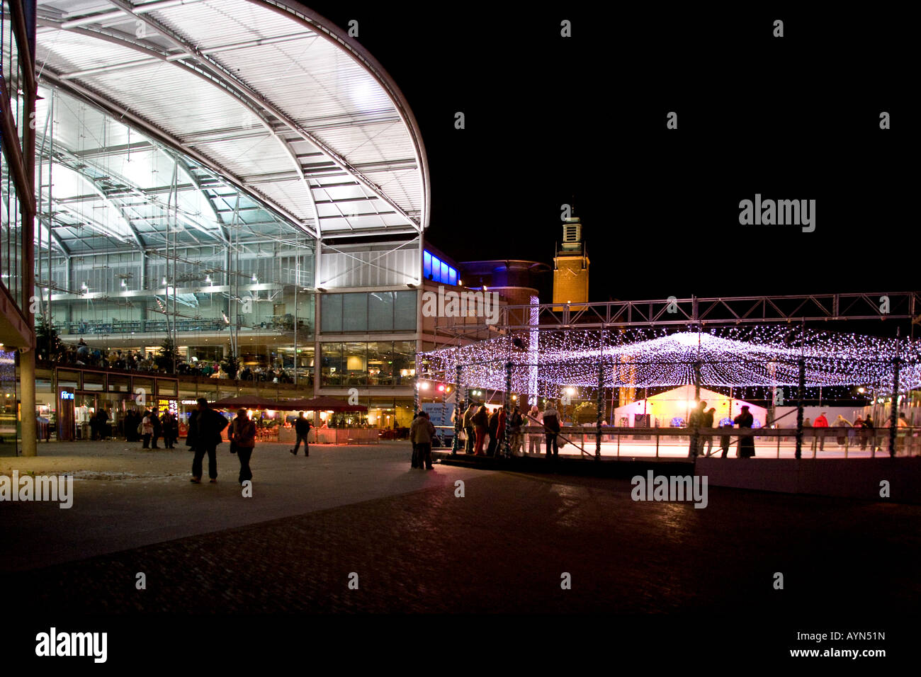 Christmas night scene at the Forum in Norwich England with skating rink ...