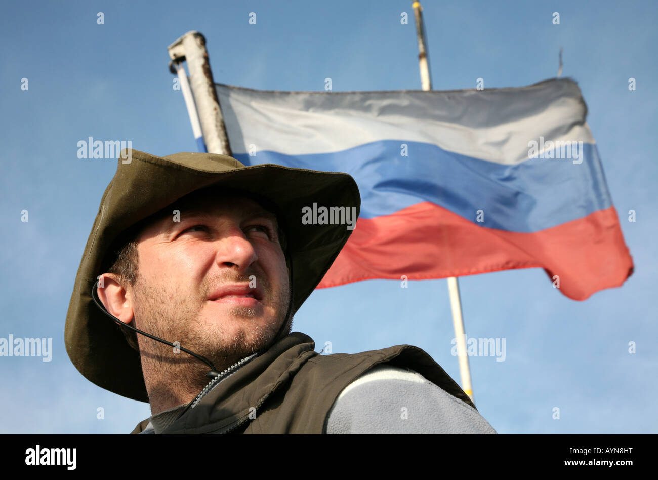 Russian pilgrim in front of Russian national flag on the tourist boat ...