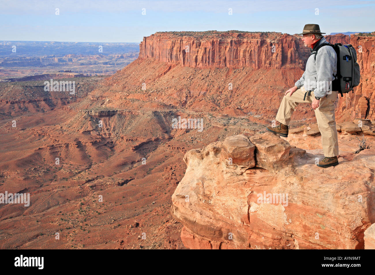Hiker camper canyon rock sandstone pack man cliff over look view scenic ...