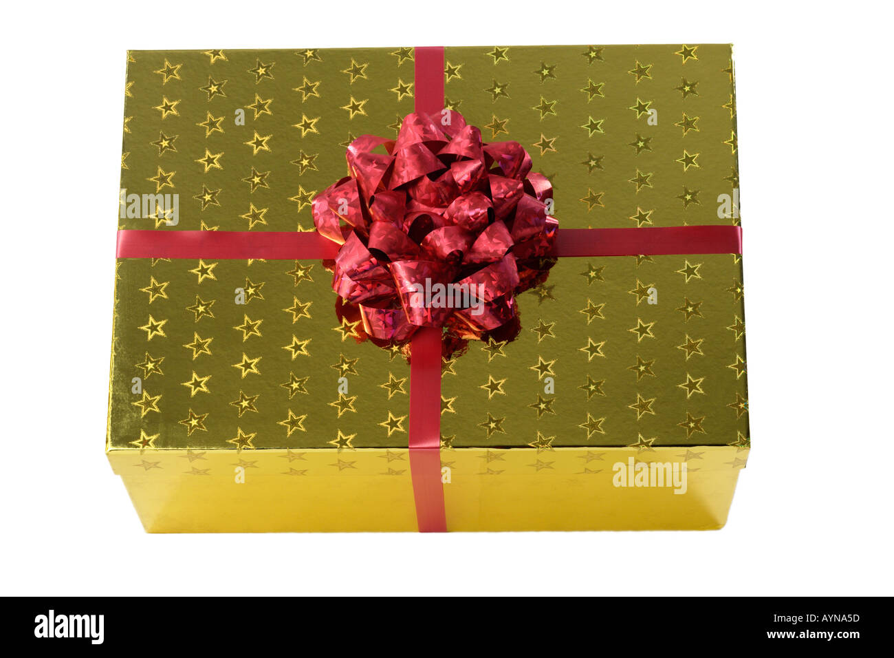 Still life of a shiny gold gift wrapped present with an ornate red bow ...