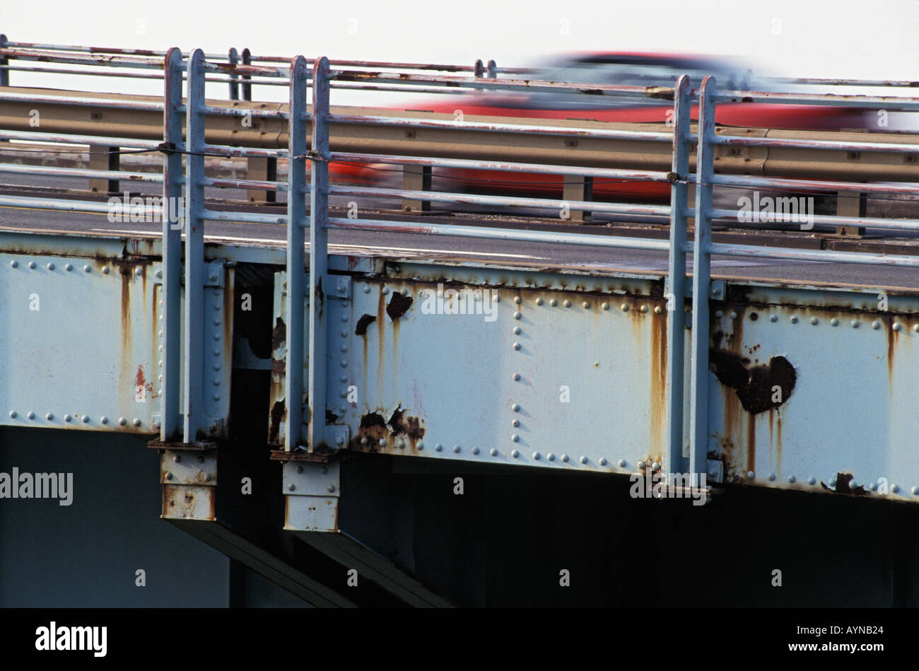 Car crossing rusted interstate bridge showing deteriorating ...