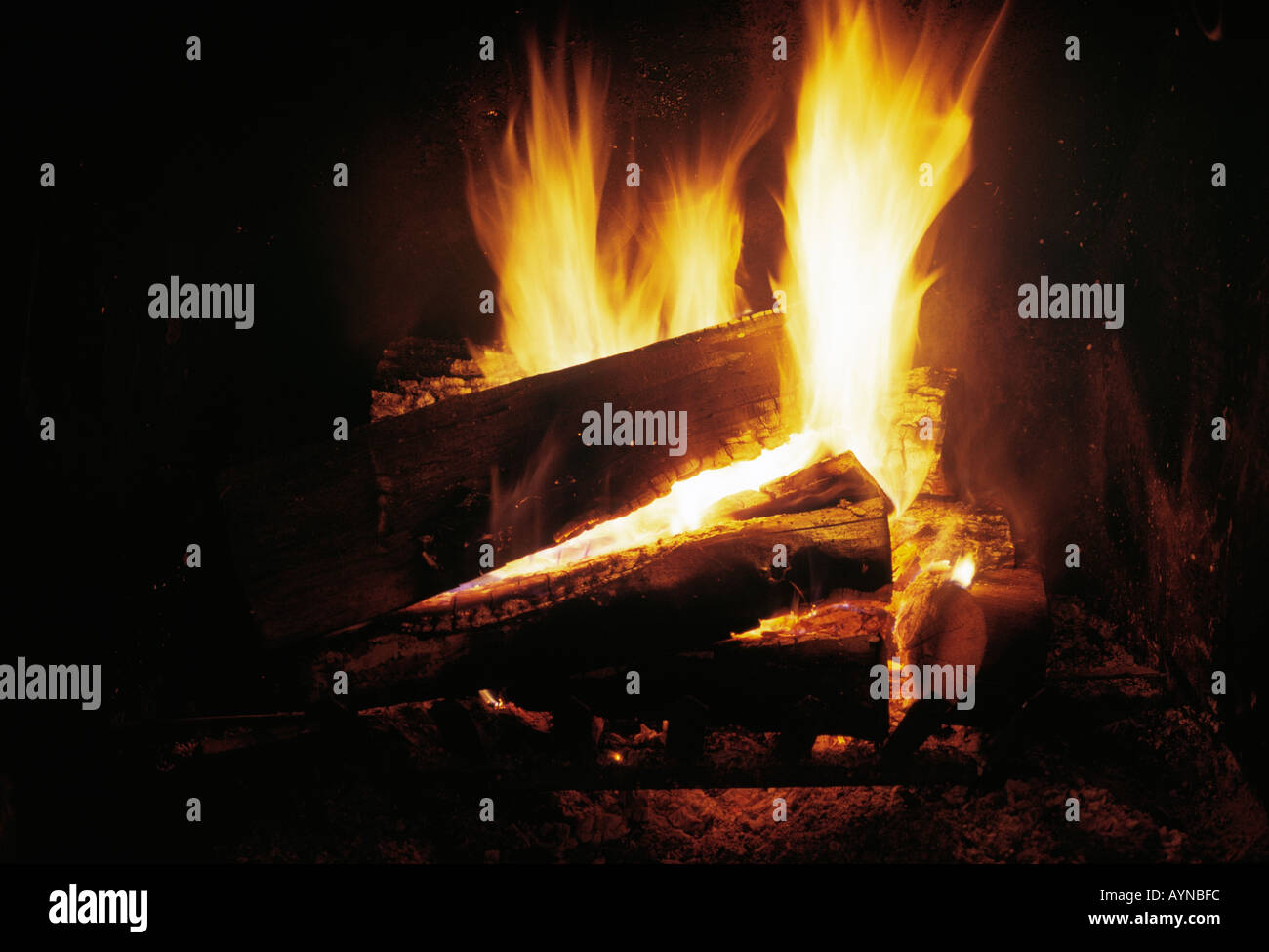 Logs blazing in fireplace Stock Photo - Alamy