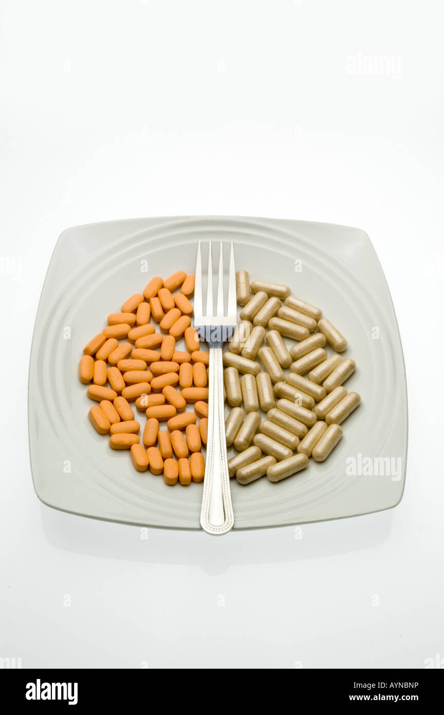 Dinner plate filled with mix of pills and capsules Stock Photo - Alamy