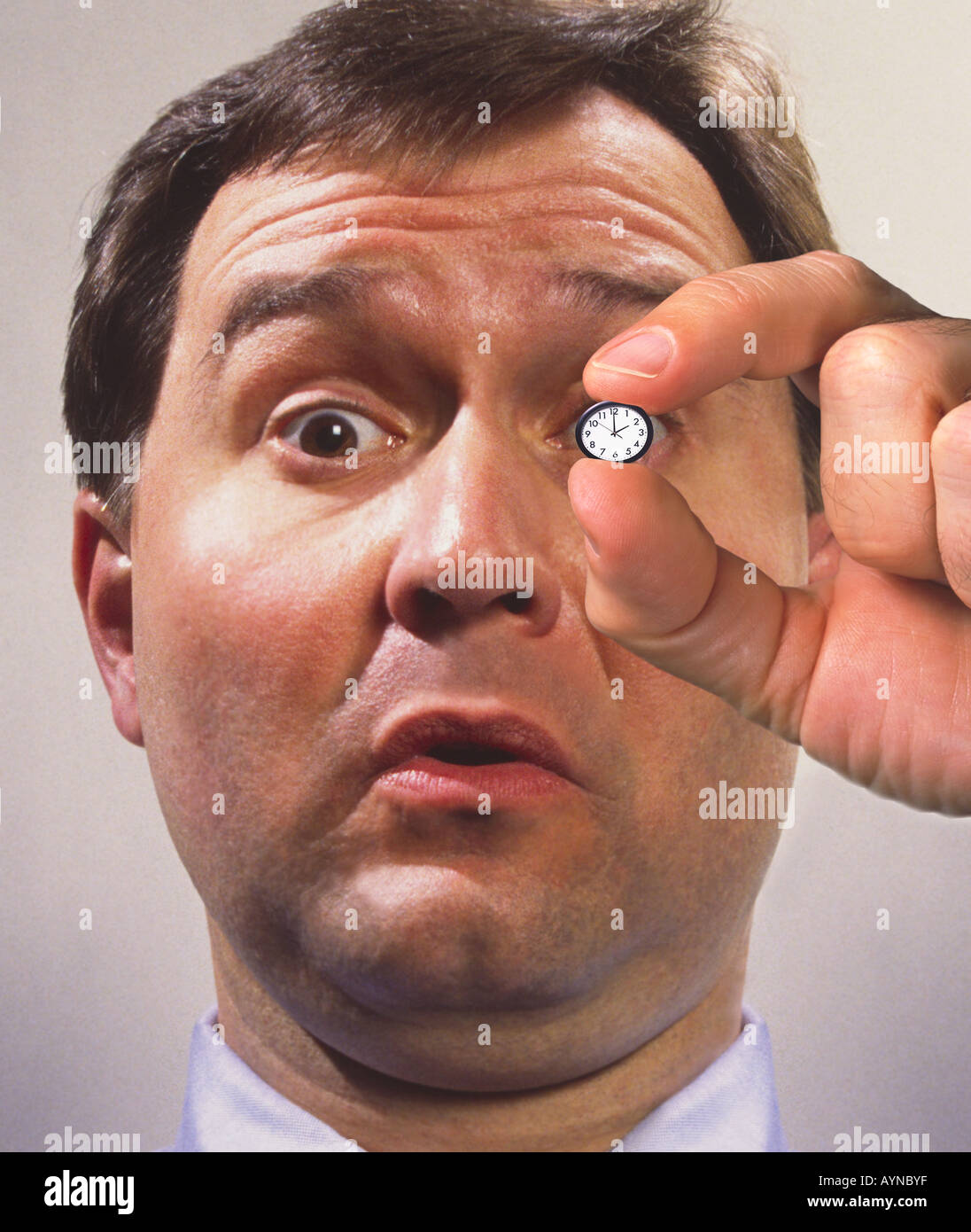 man holding tiny clock Stock Photo - Alamy