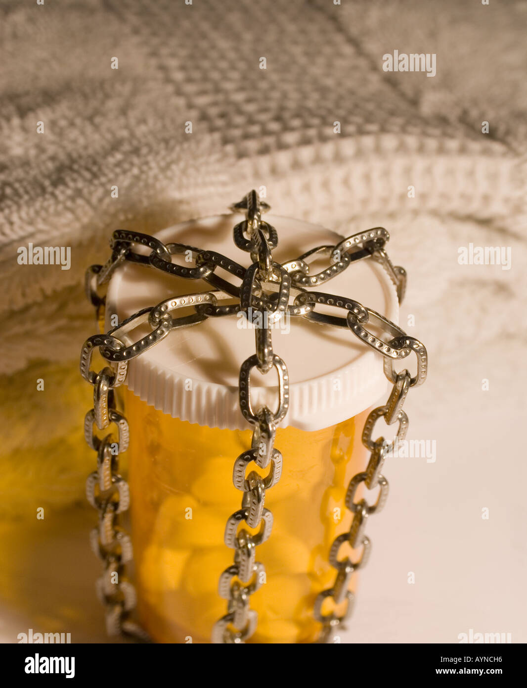 pill bottle wrapped in chains Stock Photo - Alamy