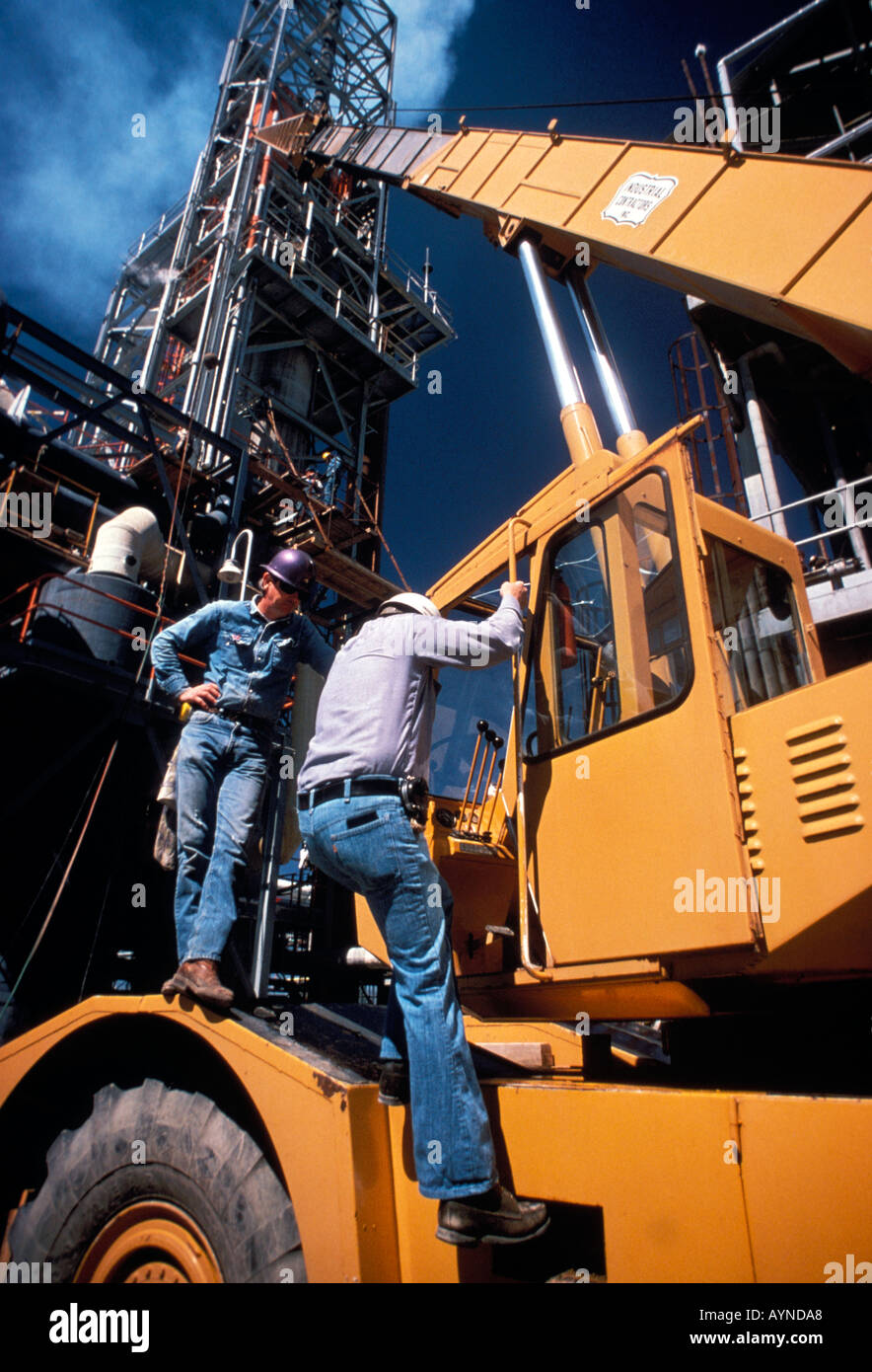 Workman operating building crane During the construction of a pulp mill Stock Photo - Alamy