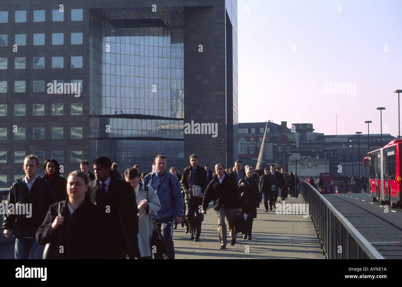 Commuters walking over London Bridge in the early morning rush hour ...