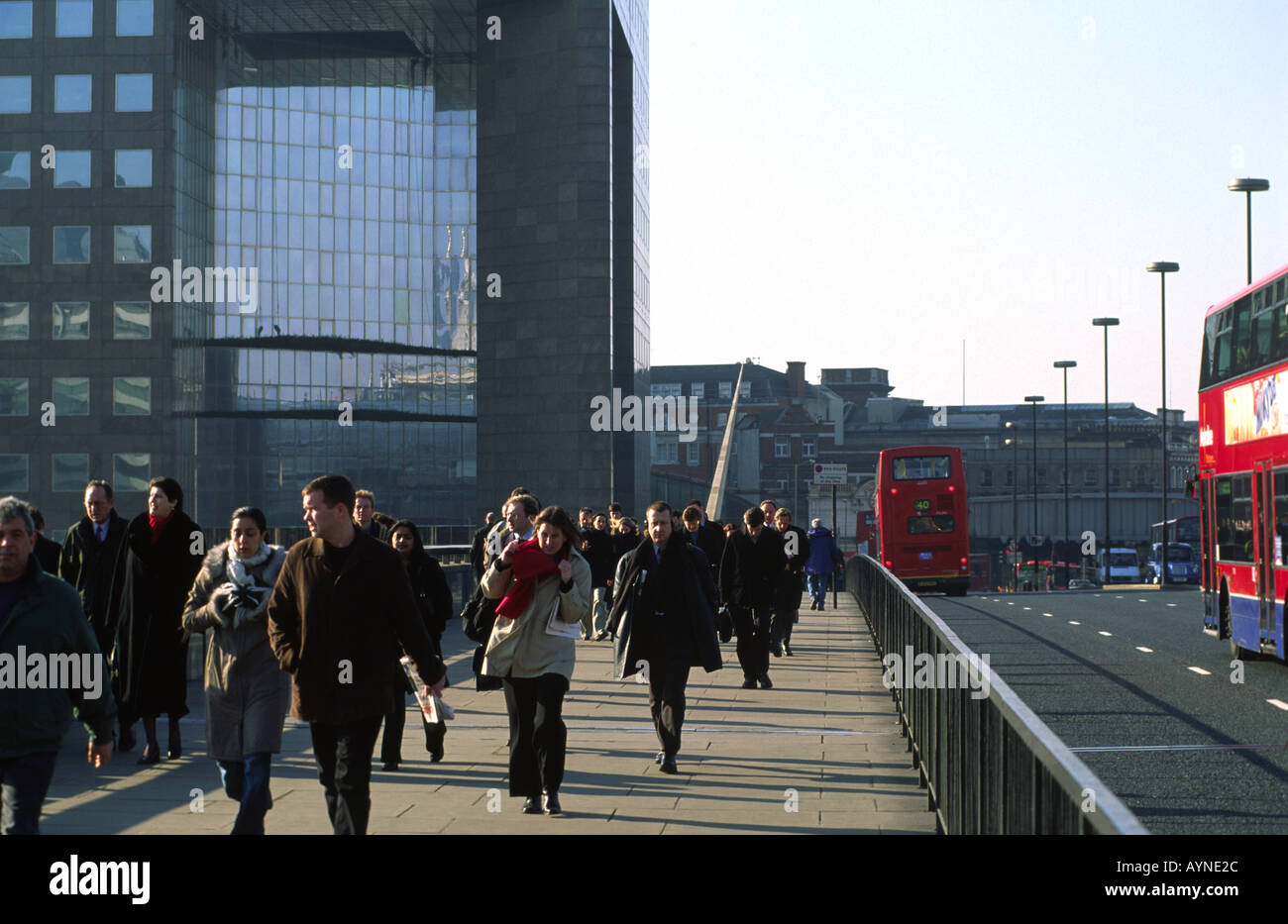 Commuters walking over London Bridge in the early morning rush hour ...