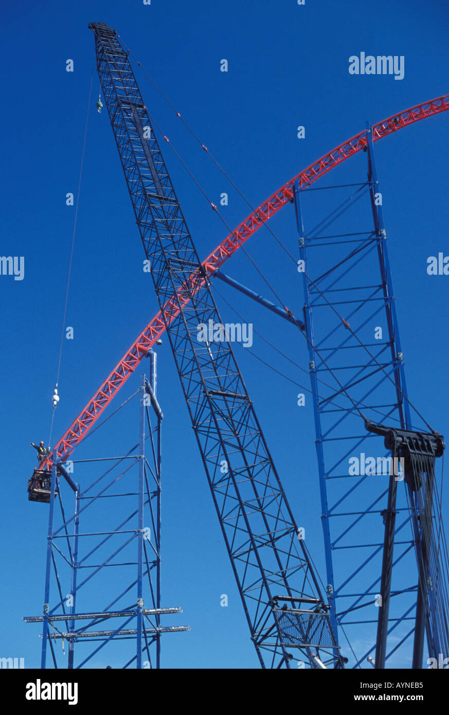 Construction crane and workman erecting the steel girders for an ...