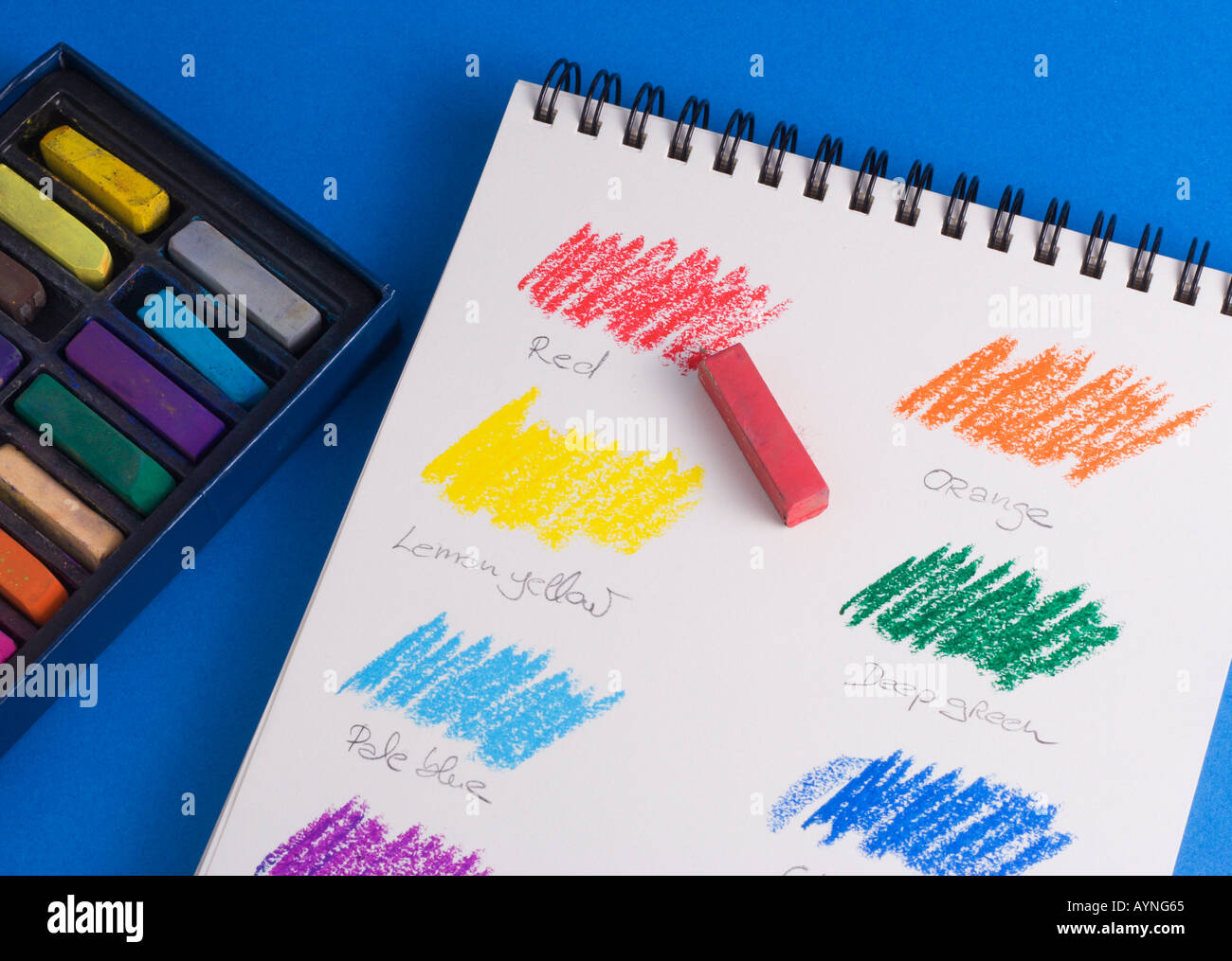 Pastel color chart hand drawn on a sketchbook on a blue background ...