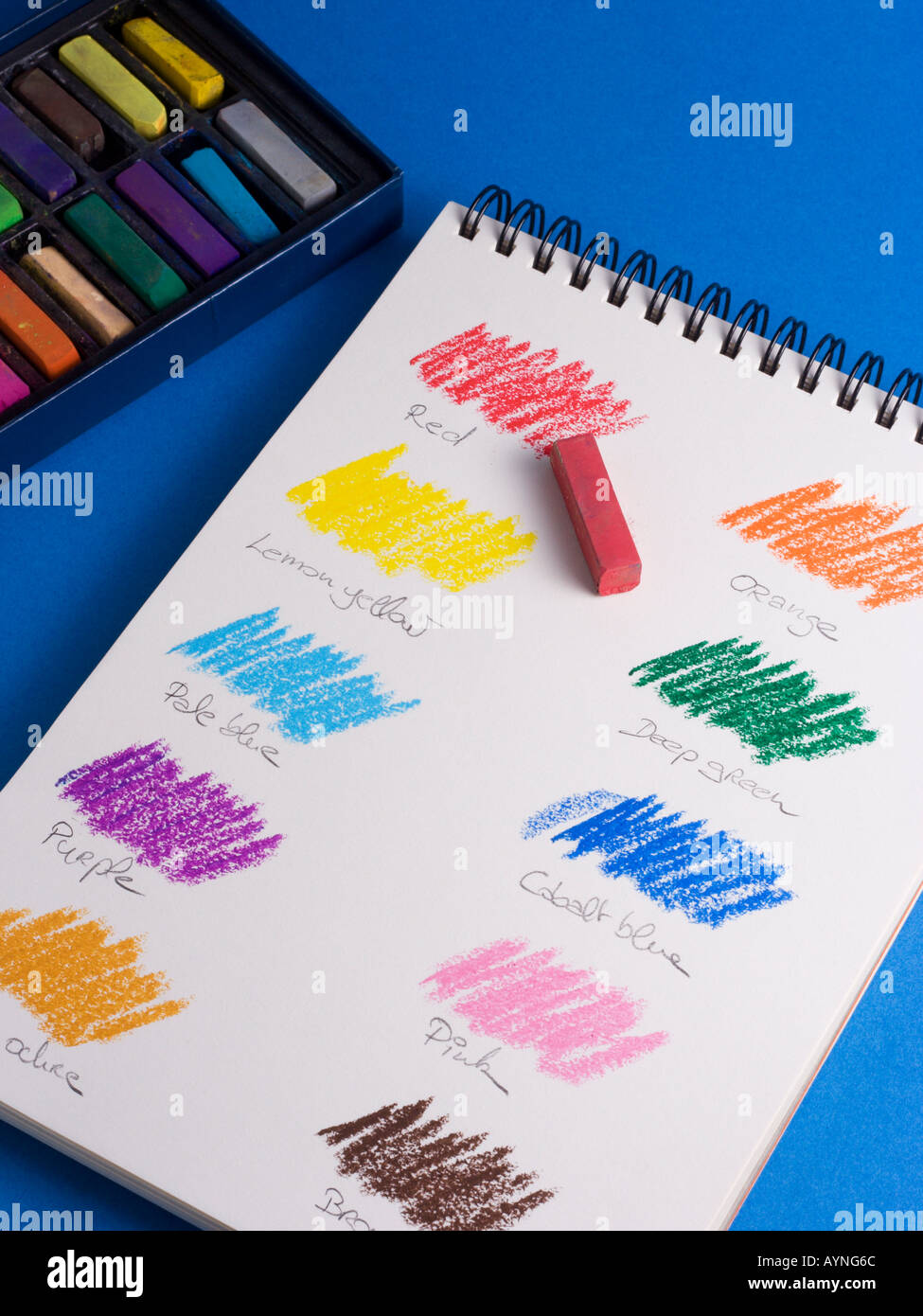 Pastel color chart hand drawn on a sketchbook on a blue background ...