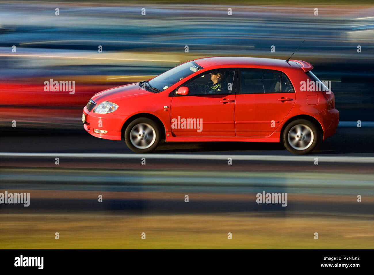 Red car merge Stock Photo - Alamy