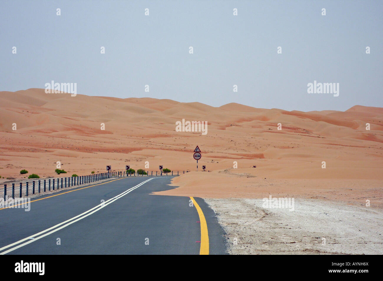A desert road through the Liwa Oasis in the Western Region of Abu Dhabi ...