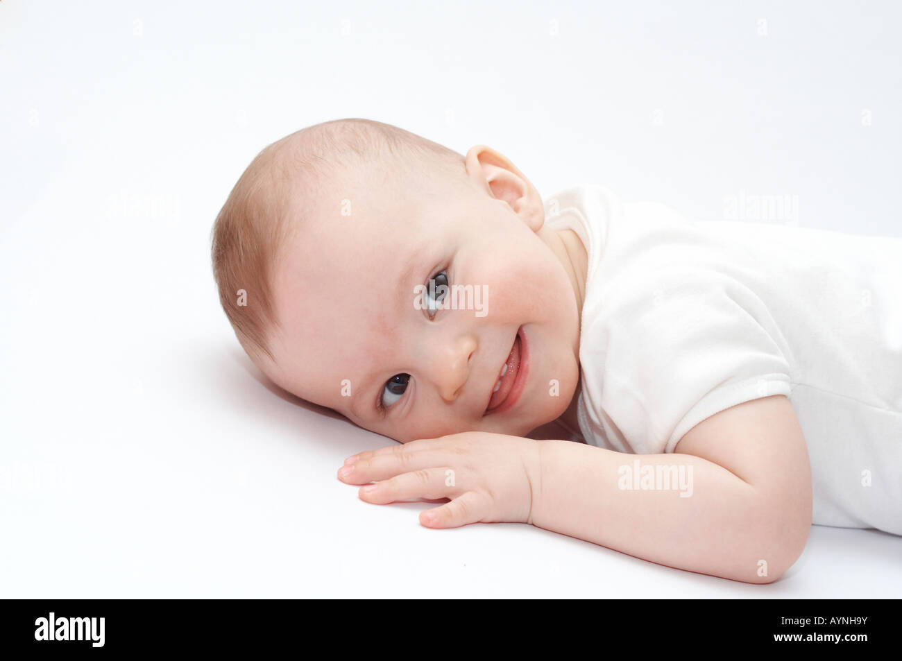 Smiling baby lying on the floor Stock Photo - Alamy