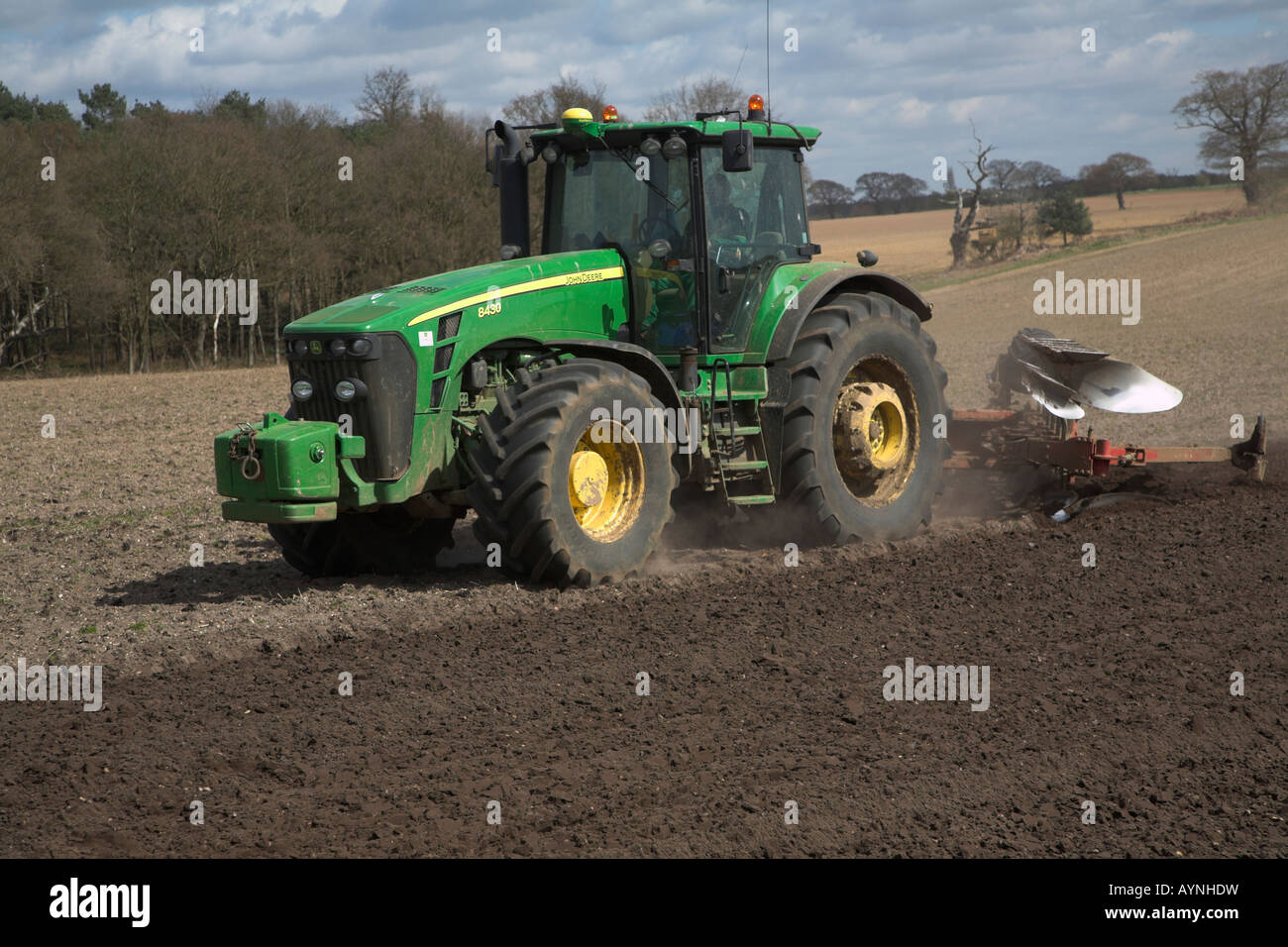 Tractor ploughing soil in preparation for potato crop, Butley, Suffolk ...