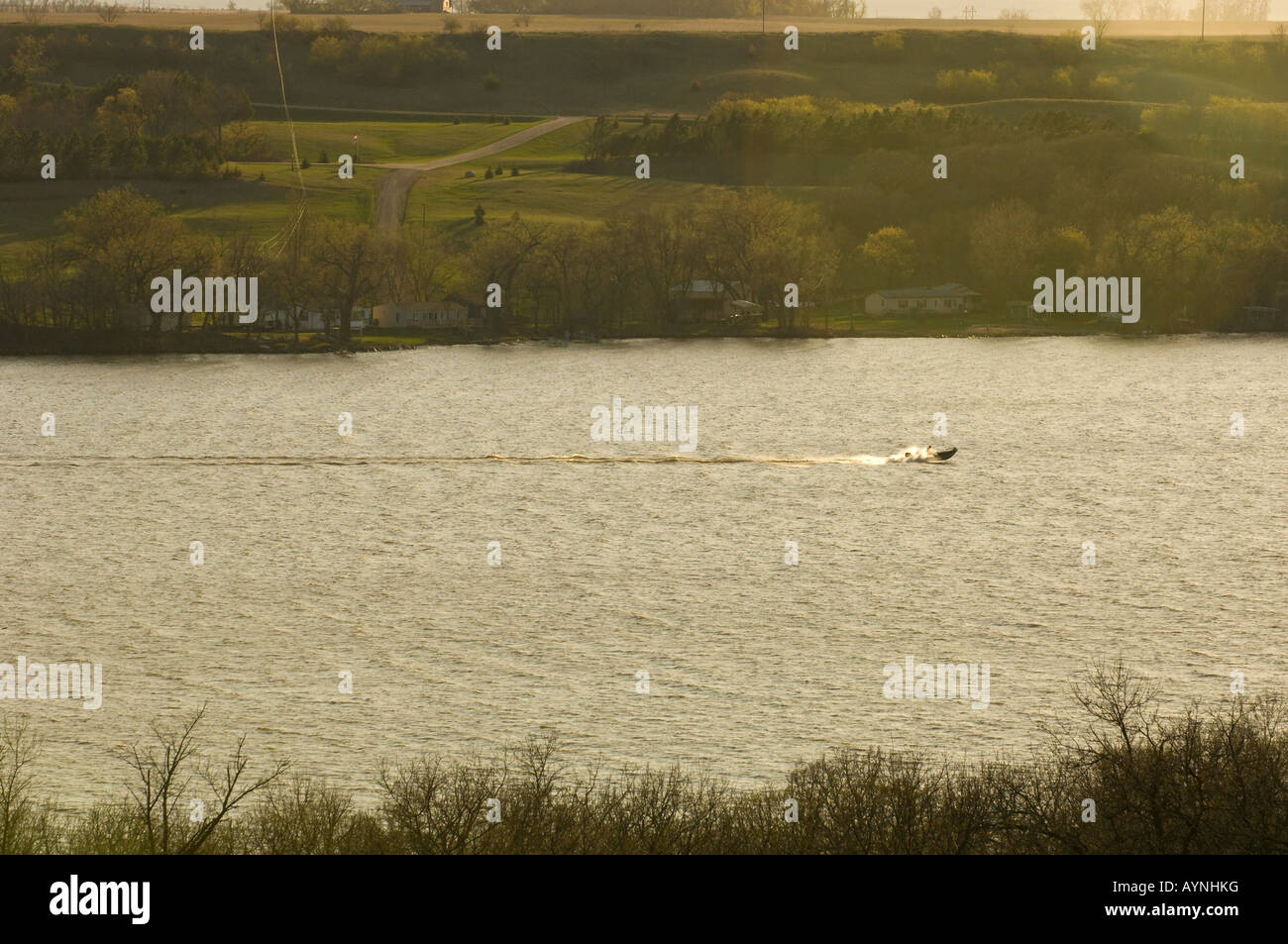 A FISHING BOAT SPEEDS ACROSS BIG STONE LAKE ON THE MINNESOTA SOUTH ...