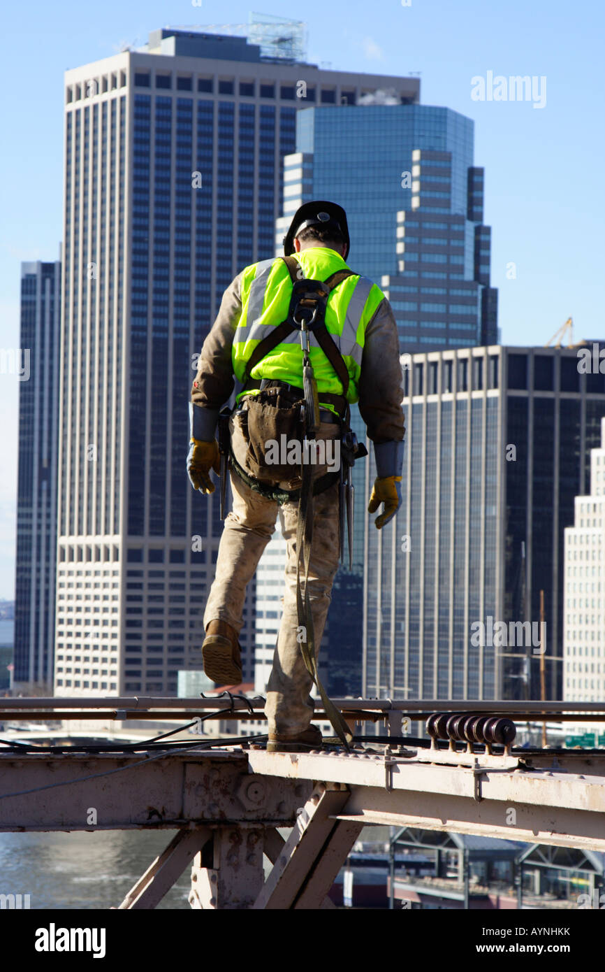 construction worker standing on ironwork of Brooklyn Bridge, New York ...