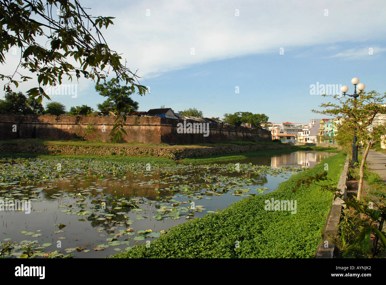 Street and sidewalk next to the moat separating the city citadel of Hue ...