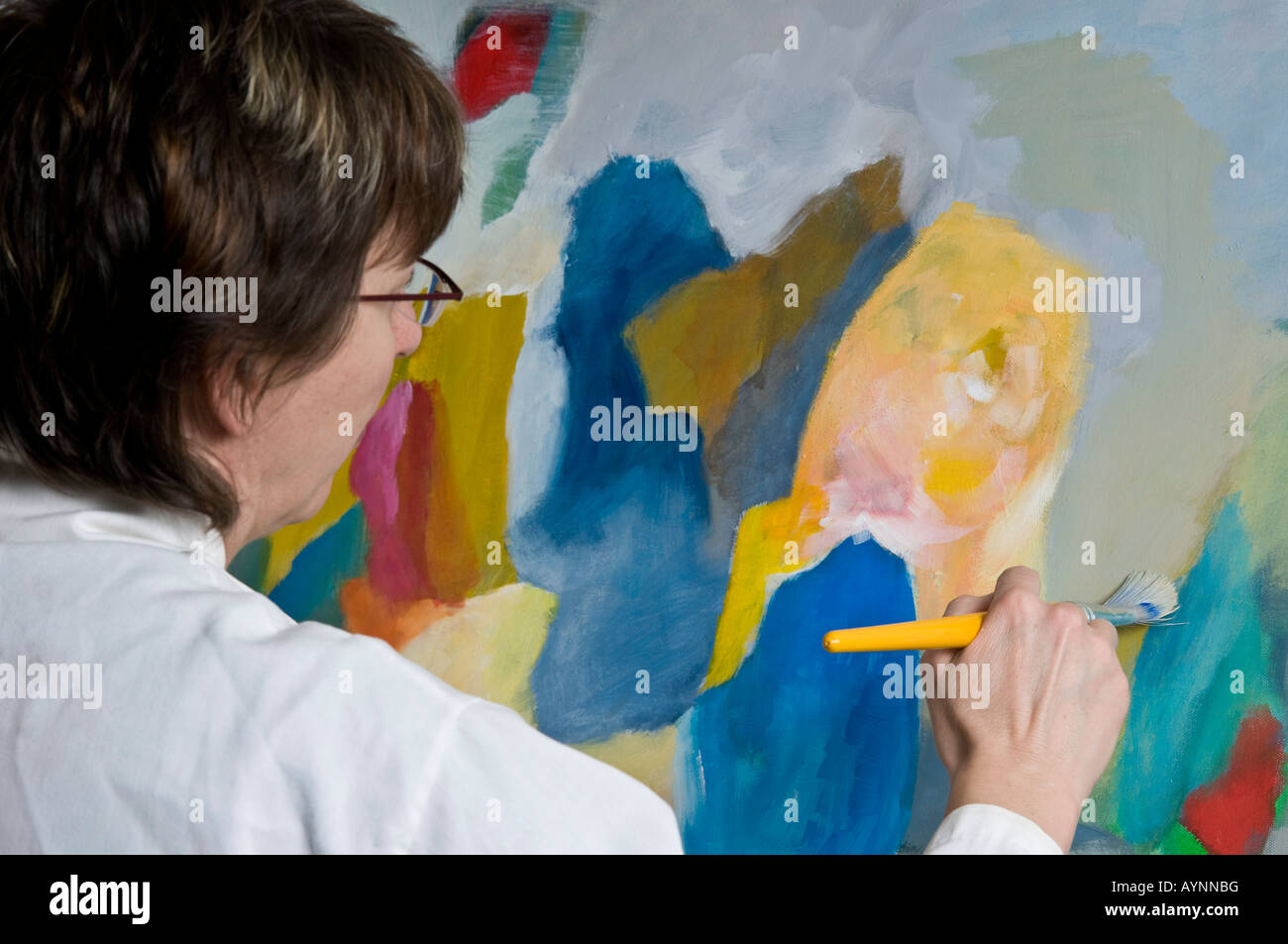 woman painting modern style art in studio on canvas with smock on Stock ...