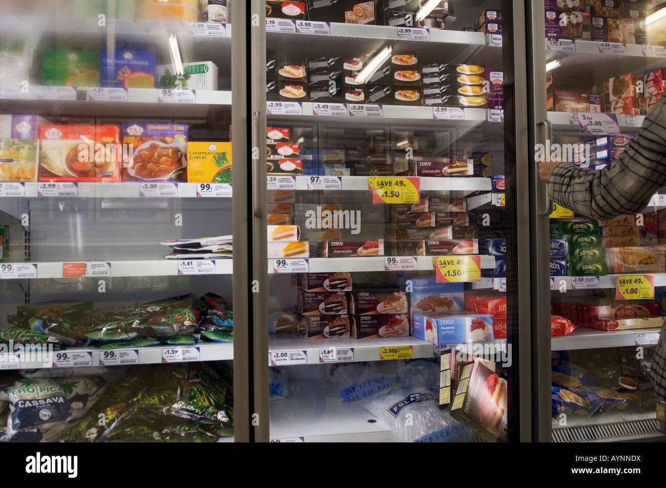 Hand opening supermarket fridge Manchester UK Stock Photo - Alamy
