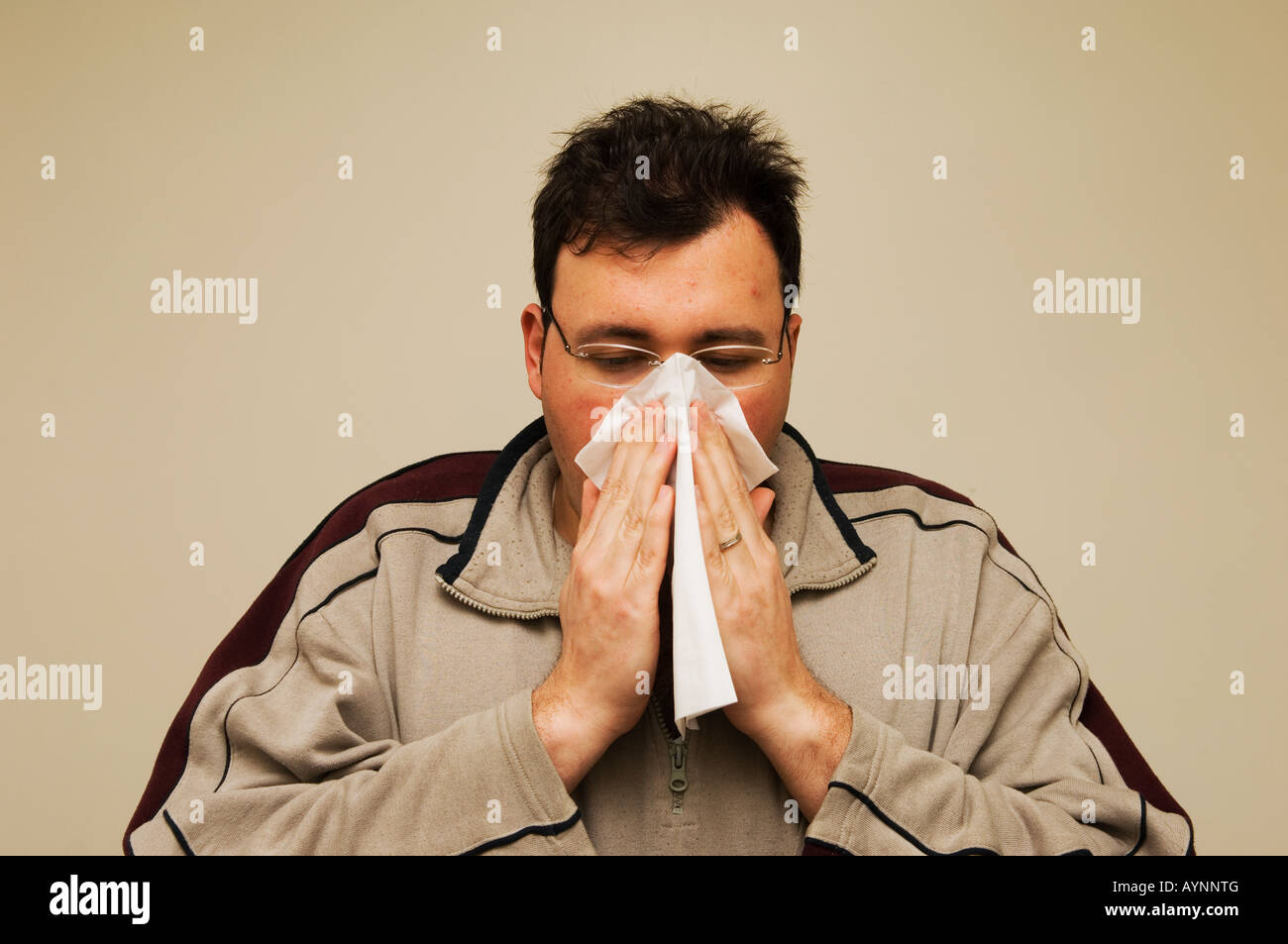 Portrait of a sick White Caucasian male blowing nose in tissue Stock ...
