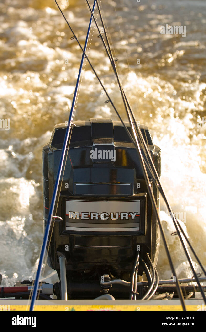 A MERCURY BOAT MOTOR ON A FISHING BOAT CREATES A WAKE ON BIG STONE LAKE ...