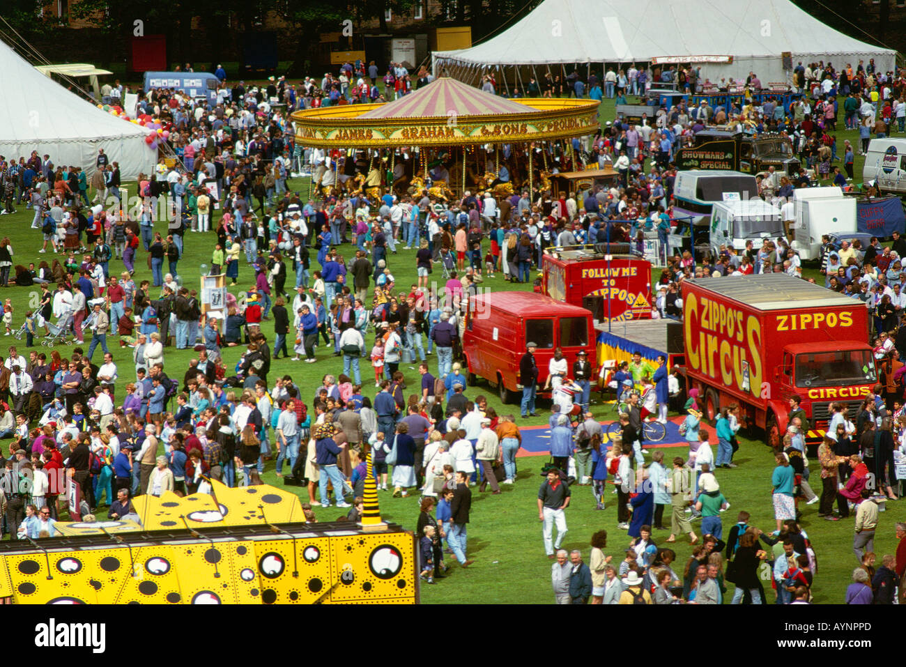 The Edinburgh Fringe Festival Crowds stroll around the various rides ...
