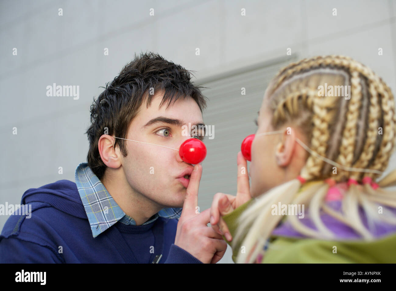 Young couple wearing red noses Stock Photo - Alamy