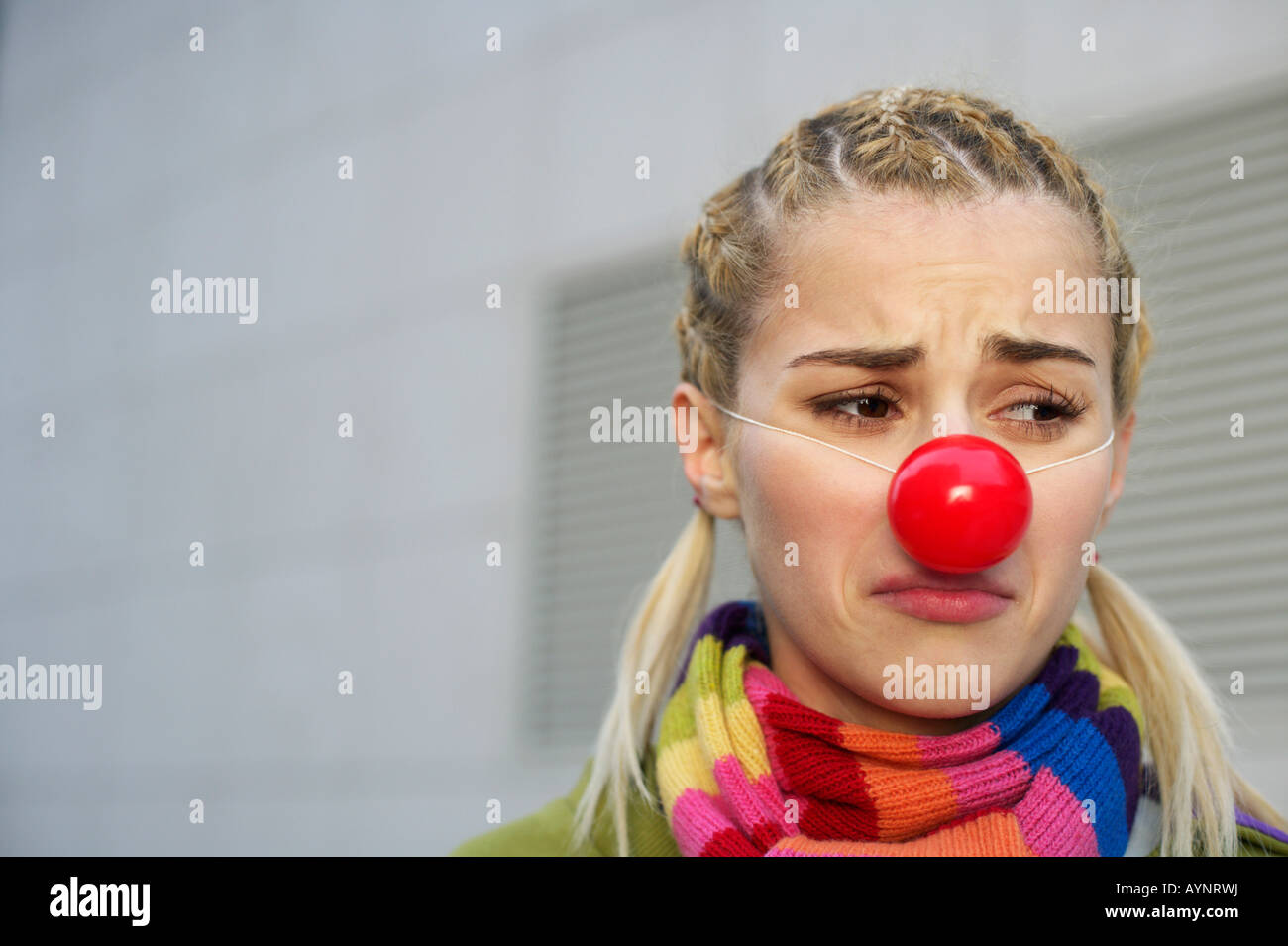 Cheerless young woman with red nose Stock Photo - Alamy