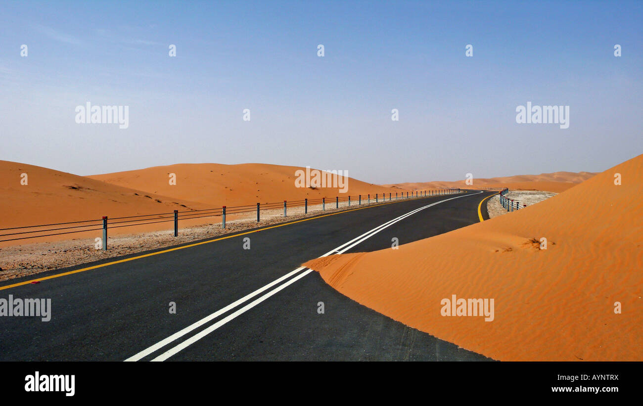 A desert road through the Liwa Oasis in the Western Region of Abu Dhabi ...
