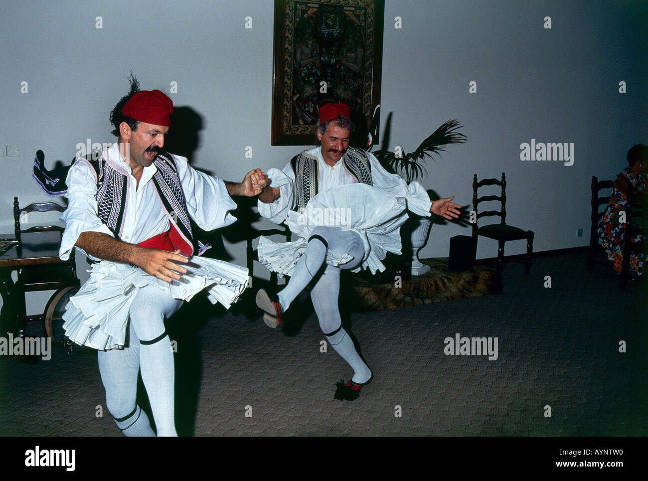 Two traditionally clad male Greek dancers performing in front of an ...