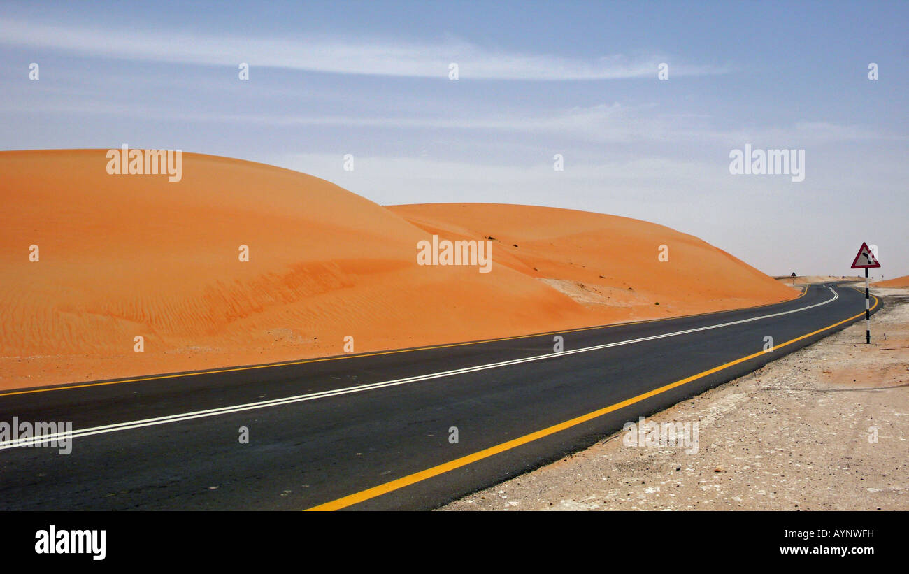 A desert road through the Liwa Oasis in the Western Region of Abu Dhabi ...