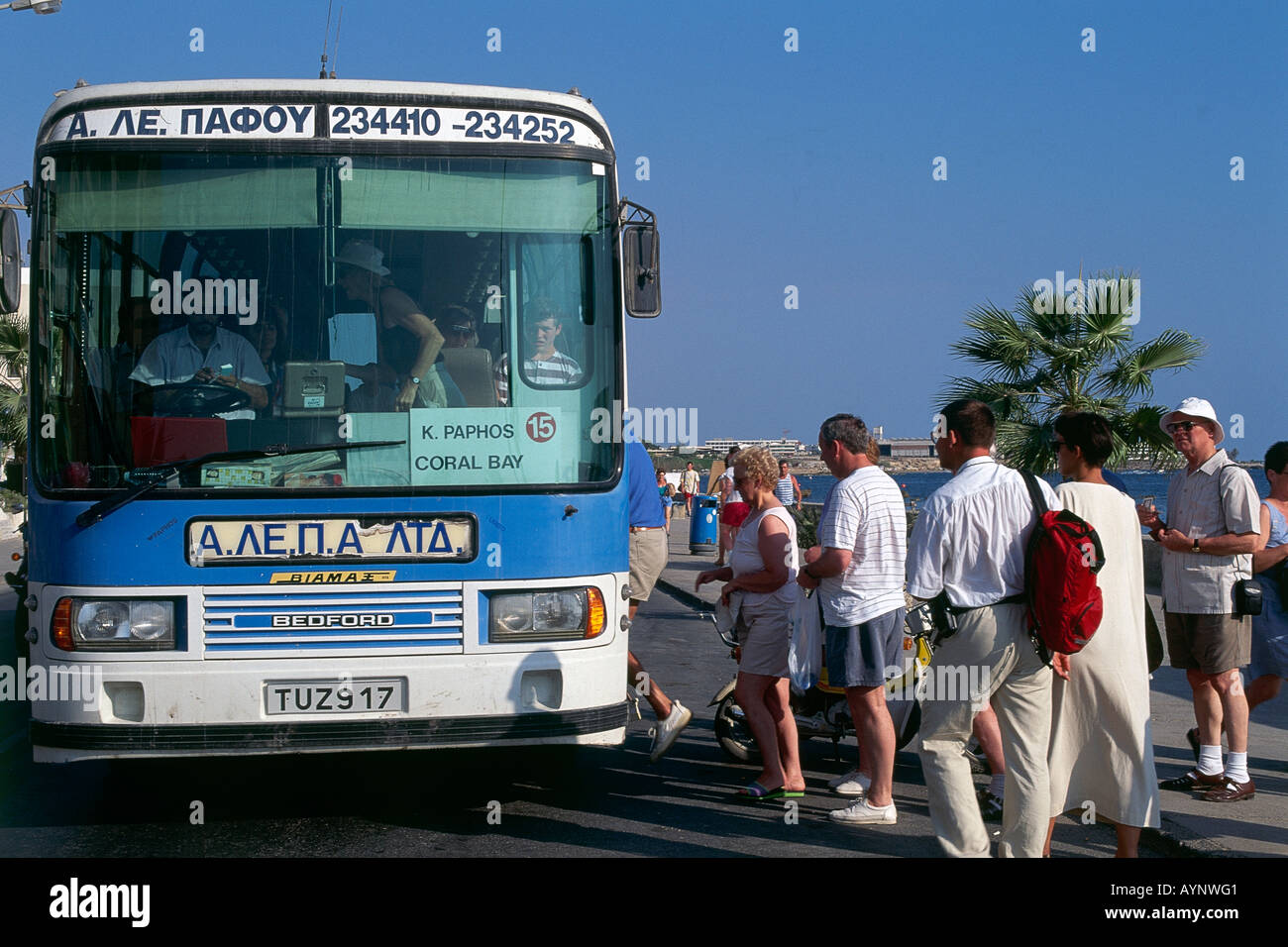 A line of holidaymakers boarding a tour bus to Coral Bay which is ...