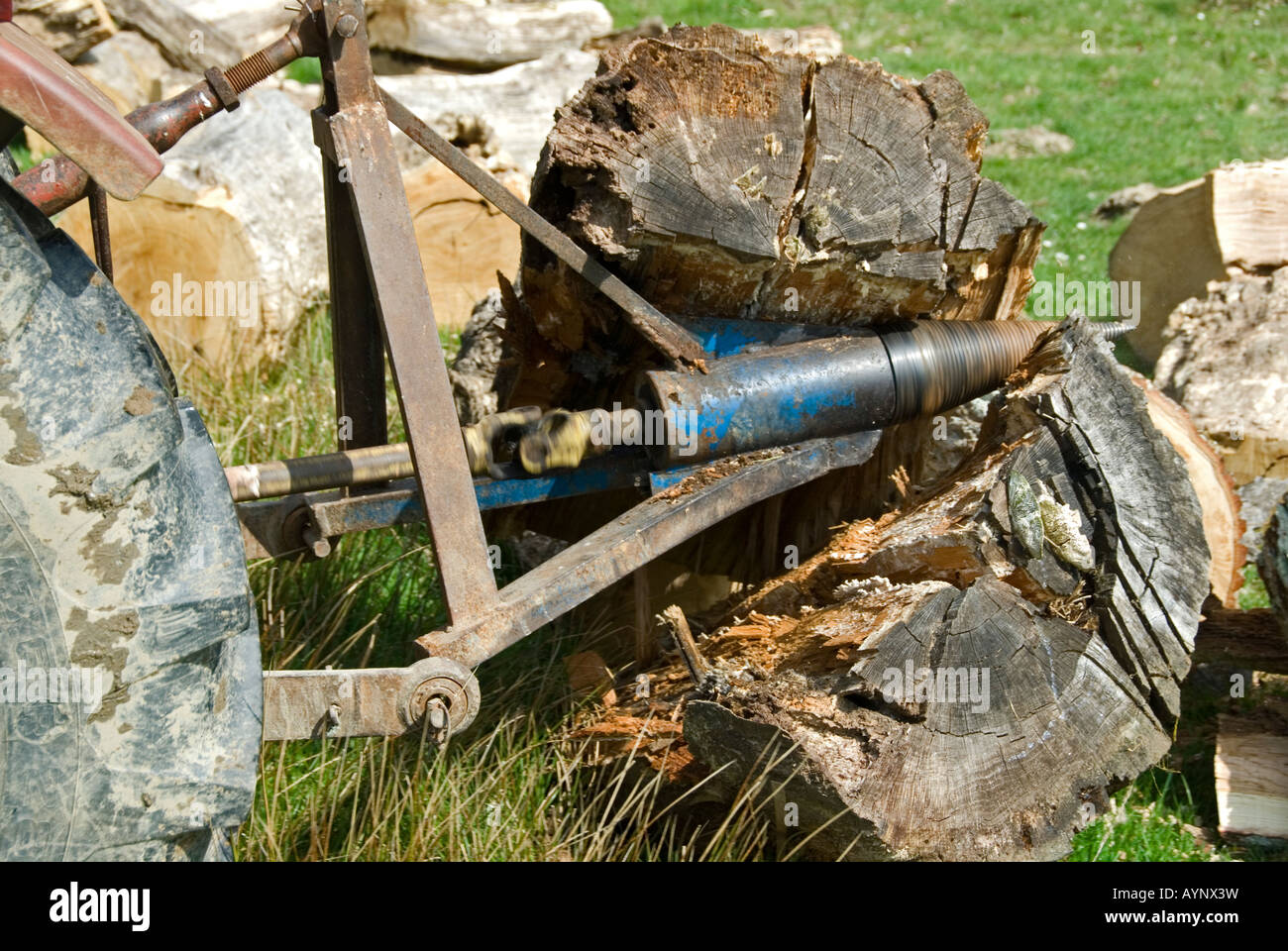 Stock photo of a tractor using a rotating threaded cone to split large ...