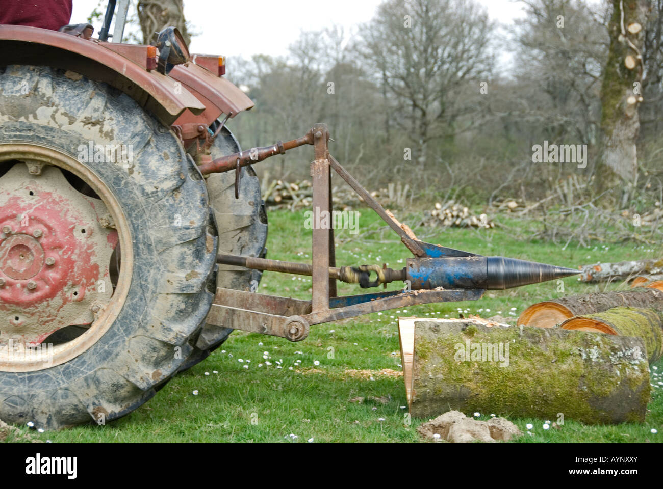 Stock photo of a tractor using a rotating threaded cone to split large ...