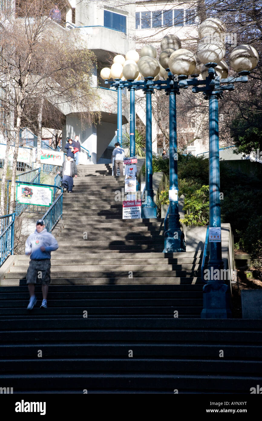Man walking on staircase outside of a building between waterfront and ...