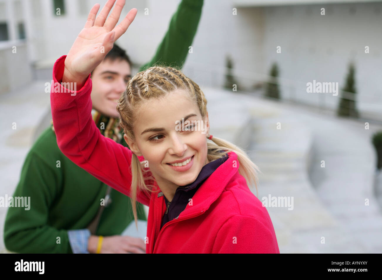 Young couple waving Stock Photo - Alamy