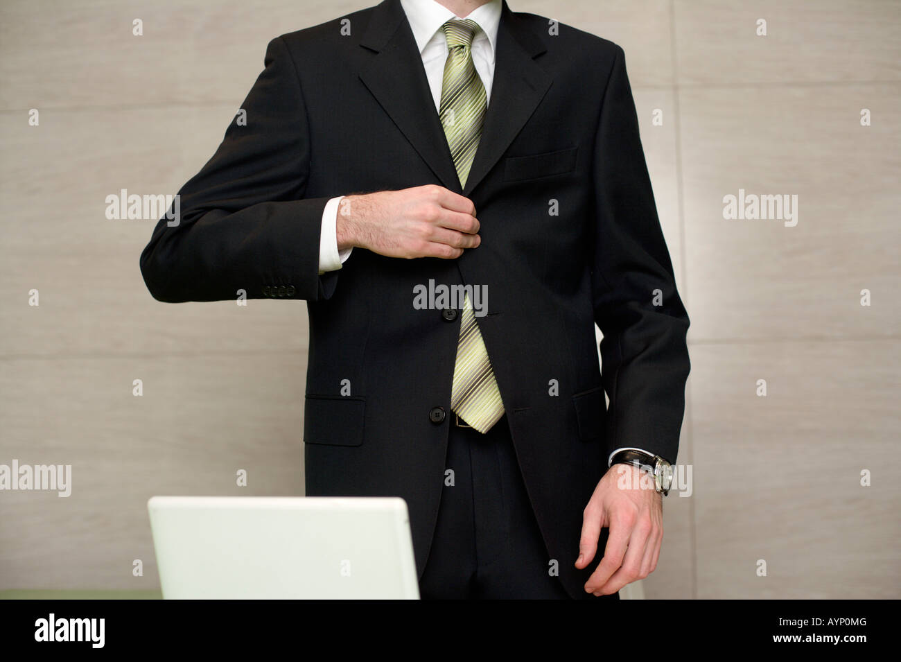Businessman buttoning up his jacket Stock Photo - Alamy