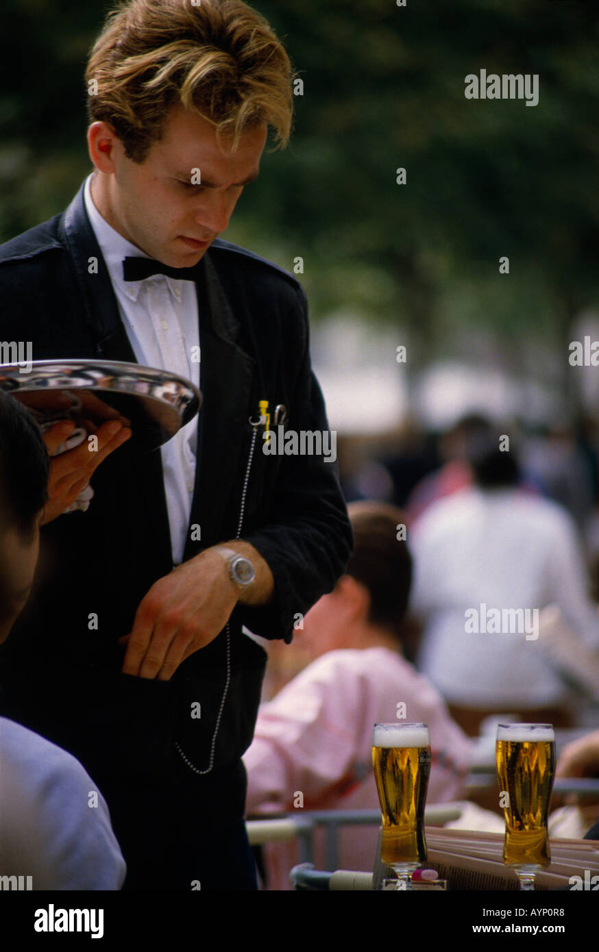 FRANCE Ile de France Paris Waiter in black tie holding tray and giving ...