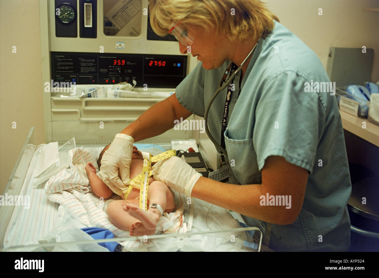 Nurse taking measurements of newborn baby Stock Photo - Alamy