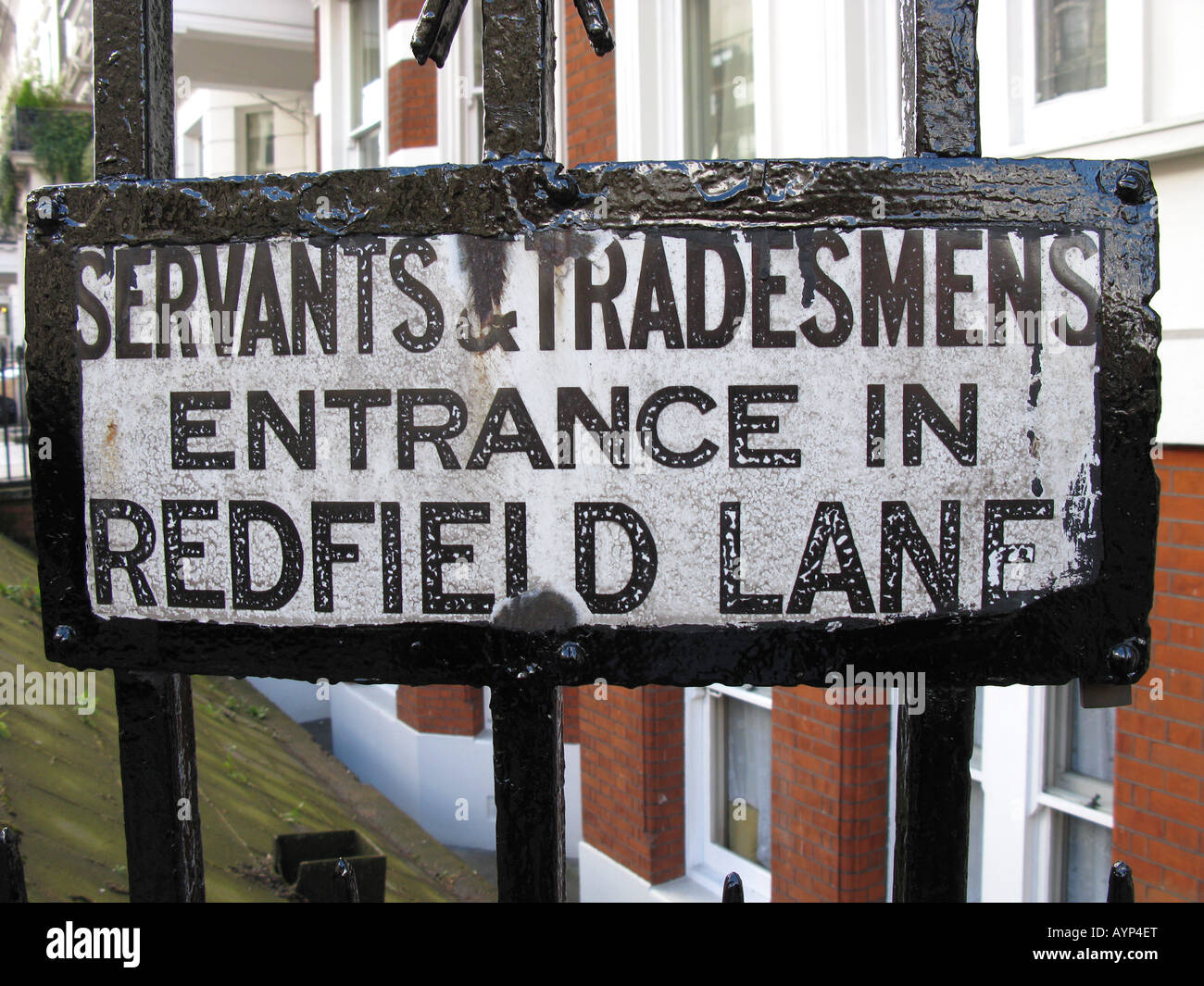 LONDON, UK. An old sign for servants and tradesmen on the railings ...