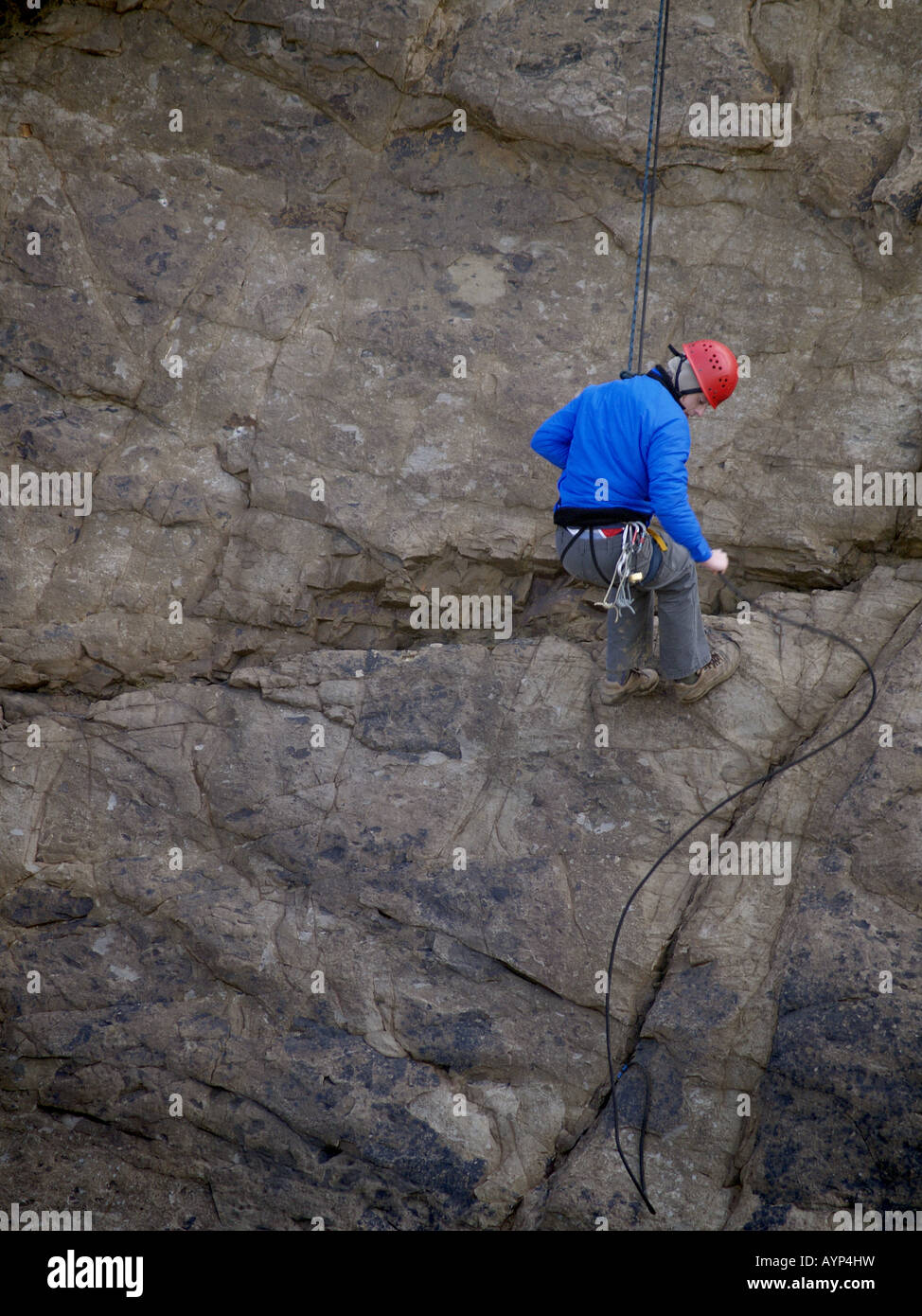 Man abseiling down a rock face Cornwall, UK Stock Photo - Alamy