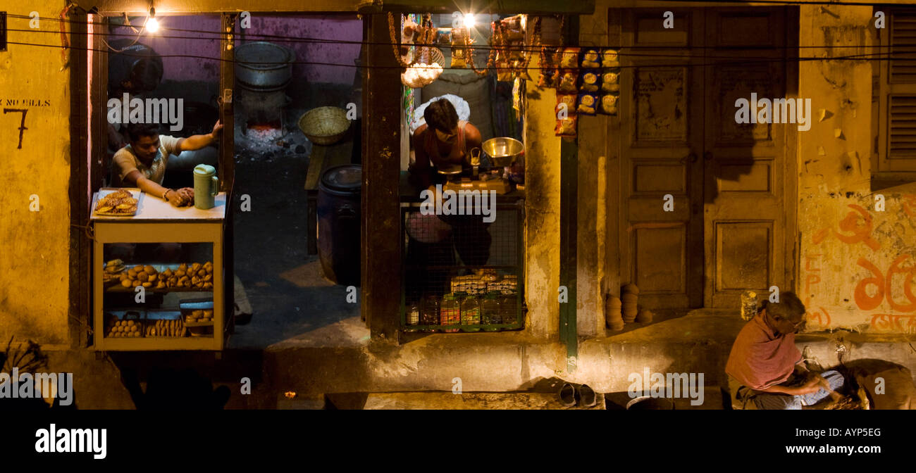 Men watch an old man from a backstreet shop, Calcutta, India Stock ...