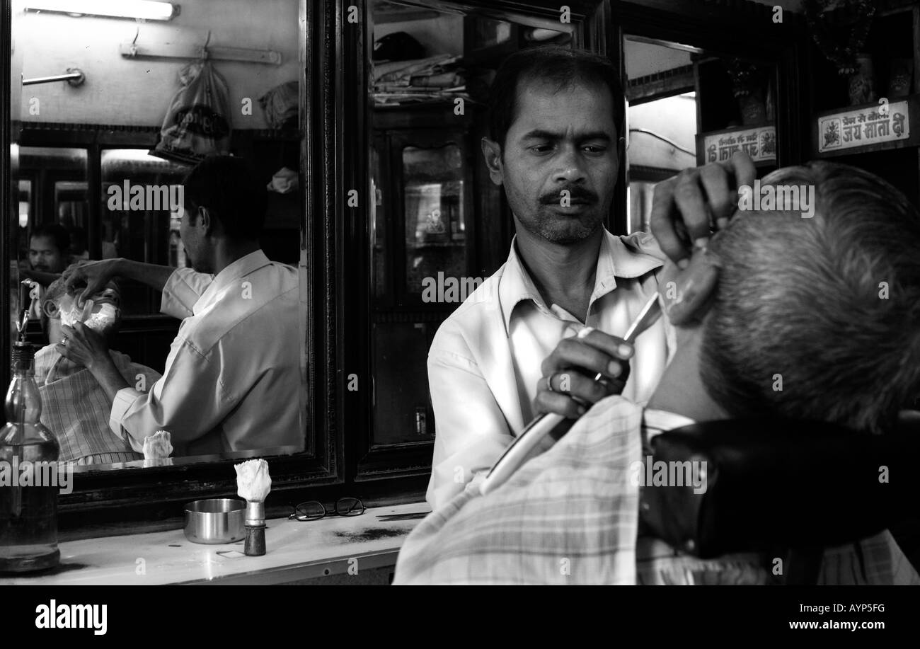 A barber shaves a customer with a cut-throat razor, Calcutta, India ...